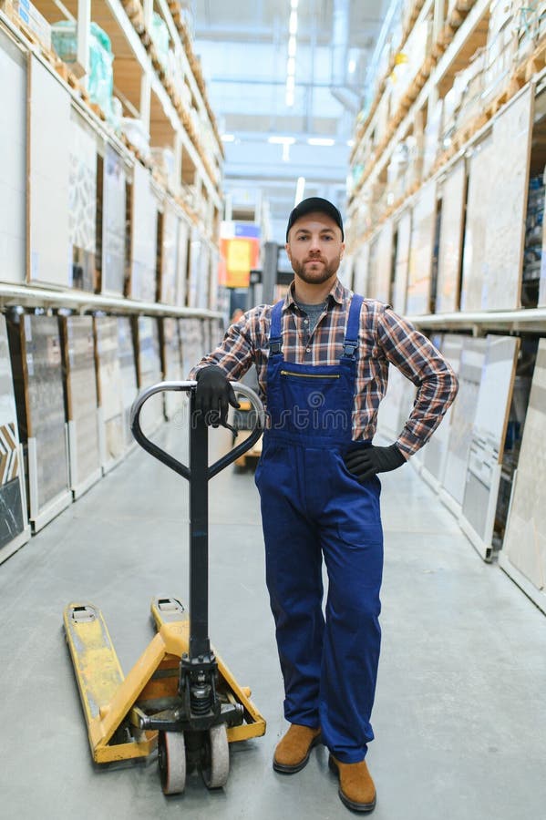 A Worker in a Hardware Store Stands in a Warehouse Stock Image - Image ...
