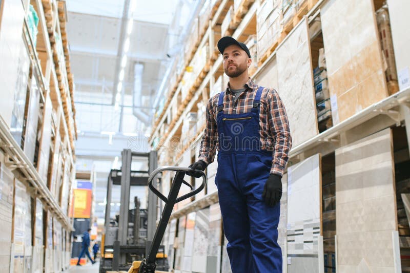 A Worker in a Hardware Store Stands in a Warehouse Stock Photo - Image ...