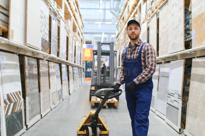 A Worker in a Hardware Store Stands in a Warehouse Stock Image - Image ...