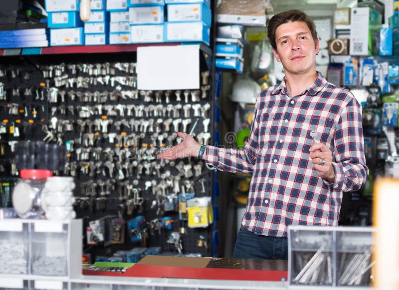 Worker in Hardware Store Trading Goods and Keys in Uniform Stock Photo ...