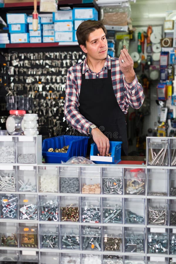 Worker in Hardware Store Trading Goods for Water Tap in Uniform Stock ...