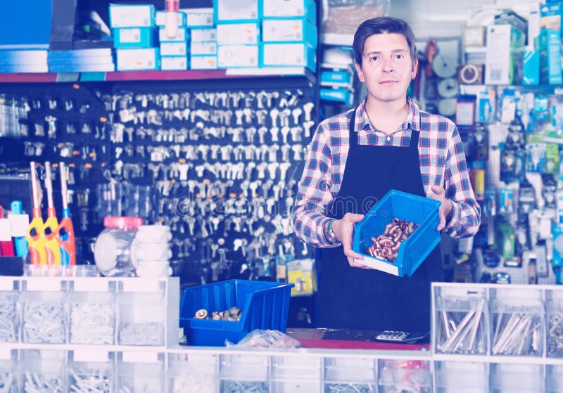 Worker in Hardware Store Trading Goods for Water Tap in Uniform Stock ...
