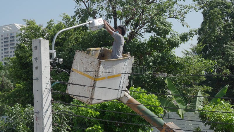 Worker on Height Lifting Platform Installing New Street Light Bulb ...