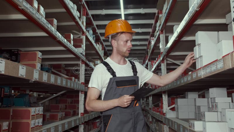 Worker in Helmet is Checking Materials at the Factory Stock Footage ...