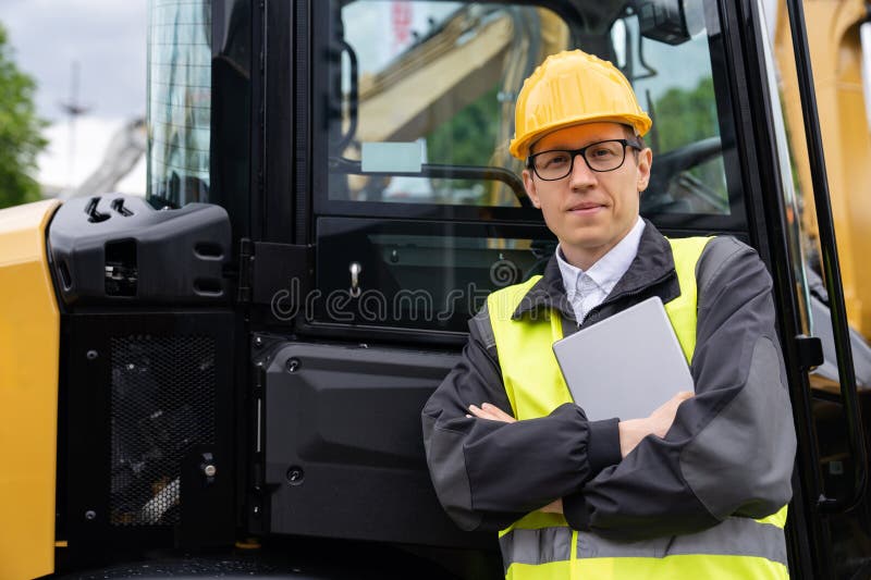 Worker in a Helmet with a Digital Tablet on the Background of ...