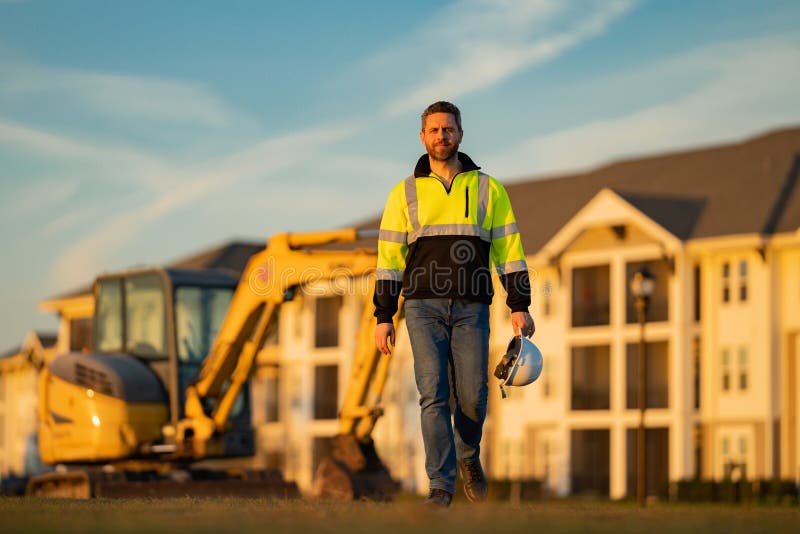Worker in Helmet on Site Construction. Excavator Bulldozer Male Worker ...
