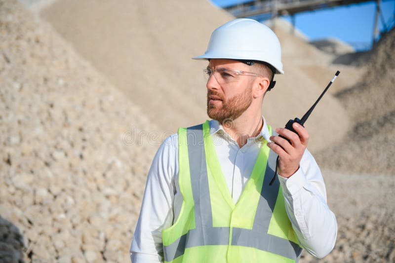 A Worker in a Helmet Stands at a Stone Crushing Plant Stock Photo ...
