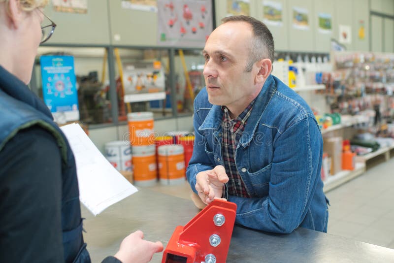 Worker Helping Customer in Hardware Store Stock Photo - Image of ...