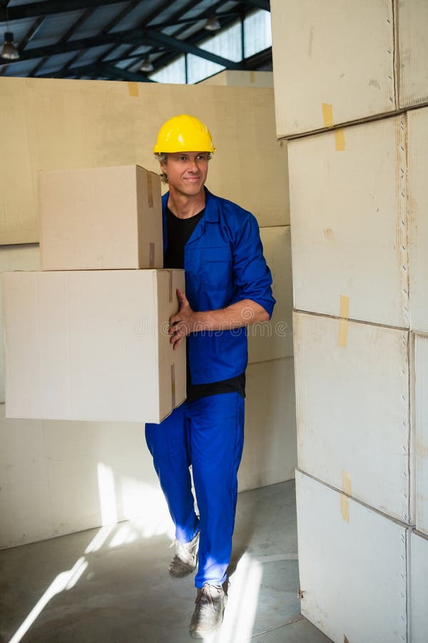 Worker Holding a Cardboard Boxes while Walking Stock Image - Image of ...