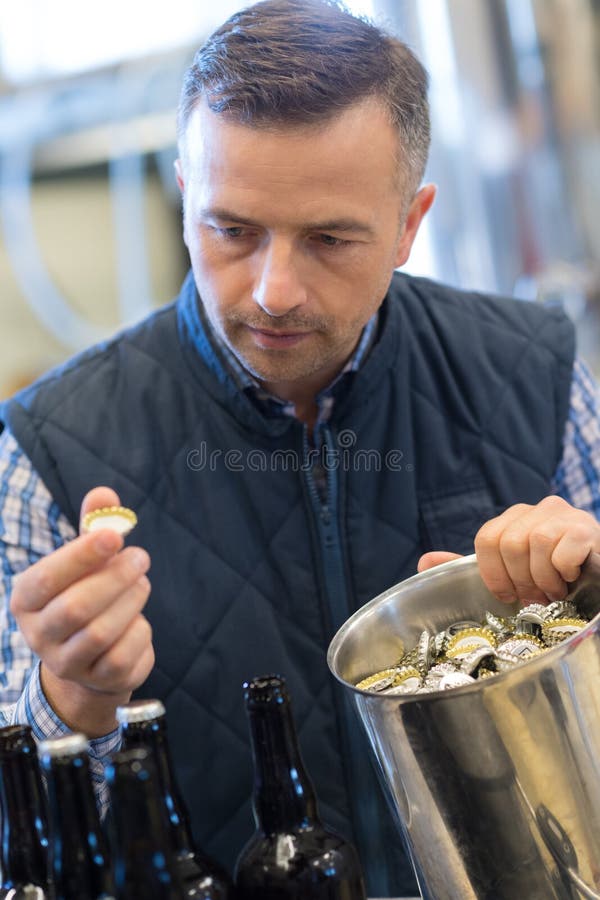 Worker Holding Container Lids for Beer Bottles Stock Image - Image of ...