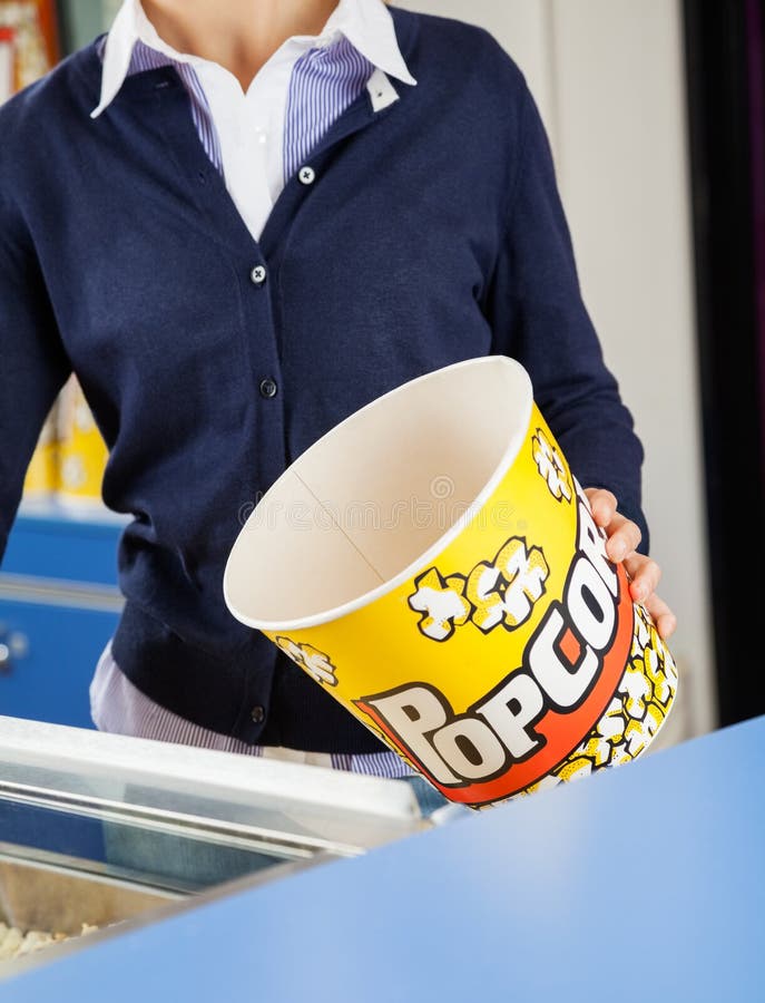 Worker Holding Empty Popcorn Bucket at Concession Stock Photo - Image ...