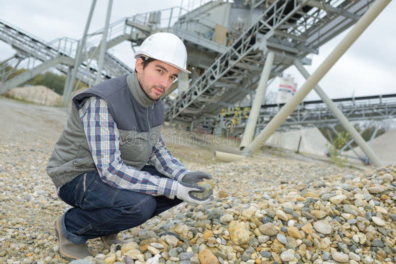 Worker holding a rock stock photo. Image of precast - 123599528
