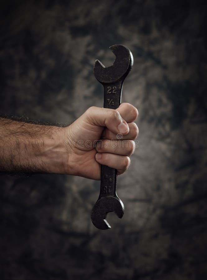 Worker holding a spanner stock image. Image of service - 98615593
