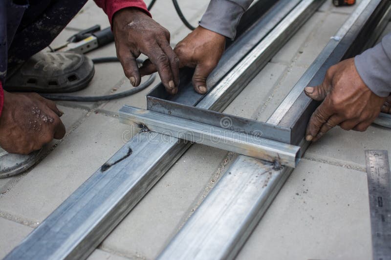 Worker Holding Steel at Construction Site Stock Image - Image of ...