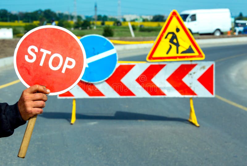 Worker Holding a Stop Sign during Road Construction. Stock Image ...