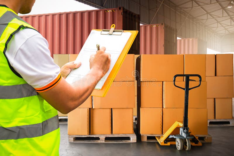 Worker Holds a Clipboard Checking the Loading Package Boxes at ...