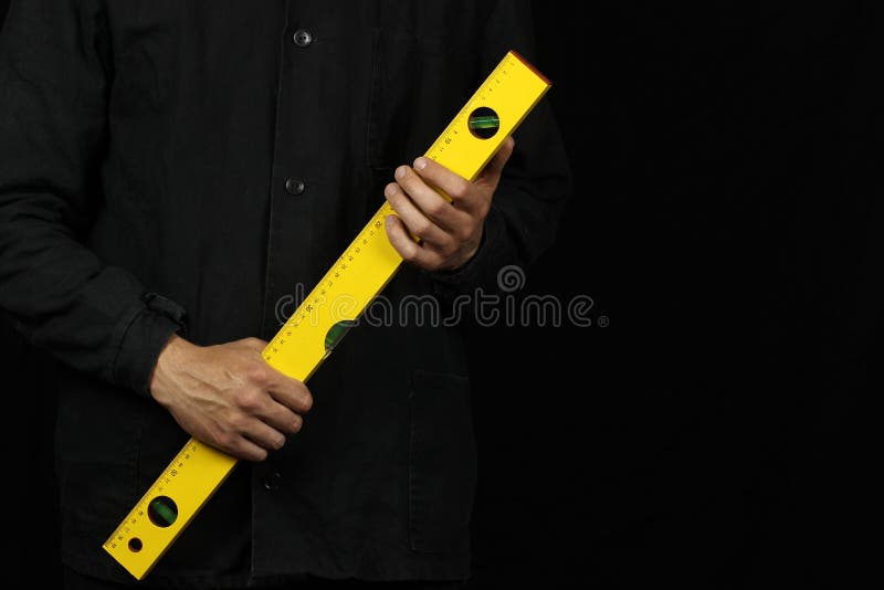 The Worker Holds the Level with Both Hands. Copy Space Stock Image ...