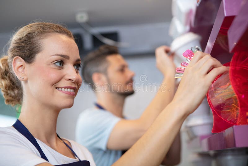 Worker in Ice Cream Parlour Refilling Plastic Spoon Dispenser Stock ...