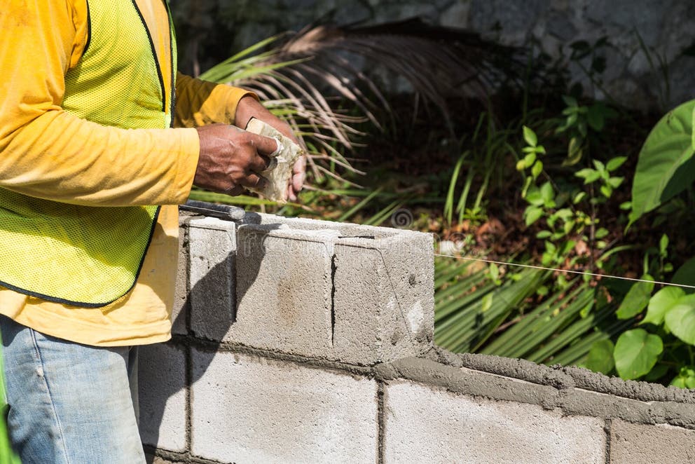Worker Inserting Noise Proofing Sponge into Barrier Bricks during ...