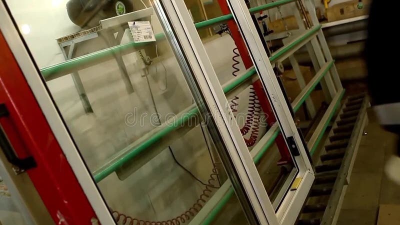 Worker Inserts the Window into the Frame of a Plastic Window. Plastic ...
