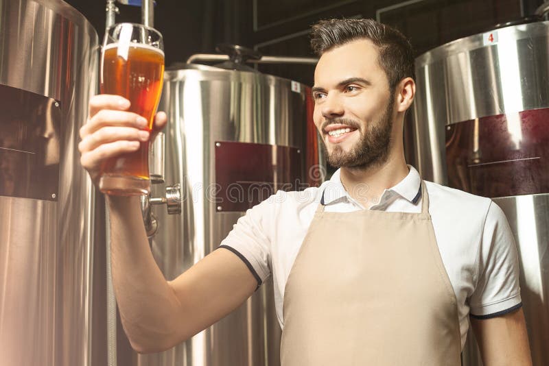 Worker Inspecting Beer at Brewery Stock Image - Image of apron, glass ...