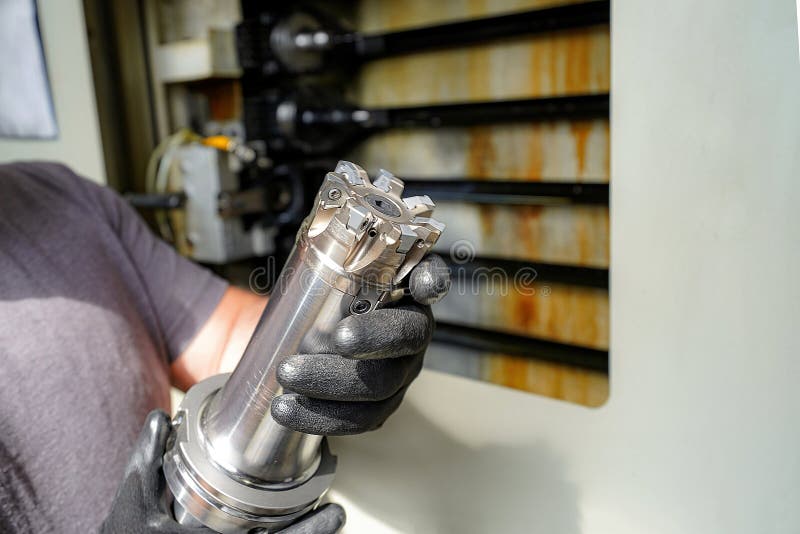 A Worker Inspects and Changes a High-speed Cutter on a CNC Milling ...