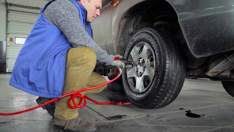 Worker Install the Wheel on a Car Stock Video - Video of automobile ...
