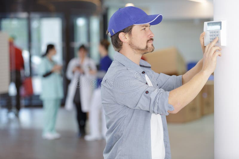 Worker Installing Alarm System in Hospital Stock Image - Image of ...