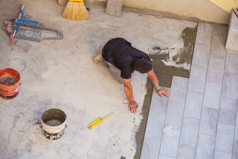 Worker Installing Ceramic Floor Tiles Editorial Photo - Image of ...