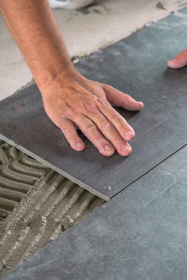 Worker Installing Ceramic Floor Tiles Stock Photo - Image of laying ...
