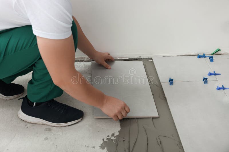 Worker Installing Ceramic Tile on Floor, Closeup Stock Image - Image of ...