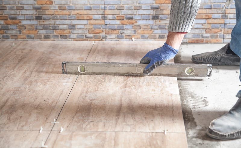 Worker Installing Ceramic Tiles Using Level Stock Image - Image of ...