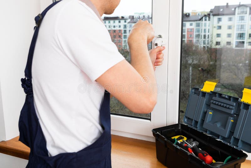 The Worker Installing and Checking Window in the House Stock Photo ...
