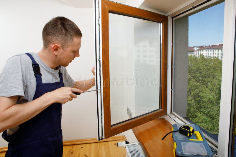 The Worker Installing and Checking Window in the House Stock Photo ...