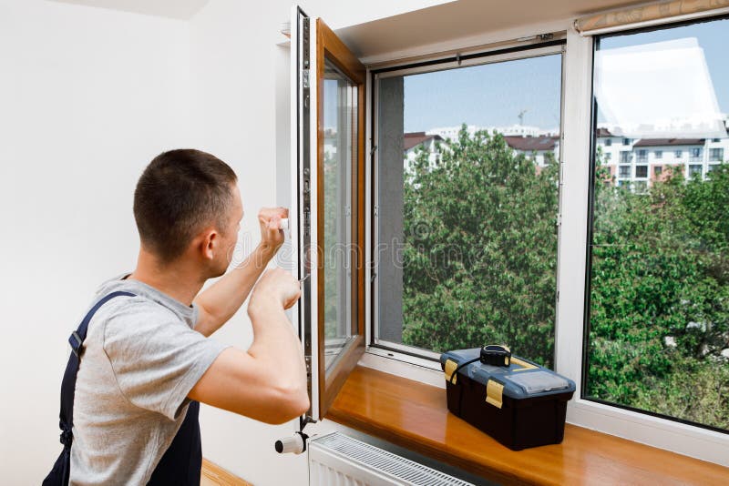 The Worker Installing and Checking Window in the House Stock Photo ...