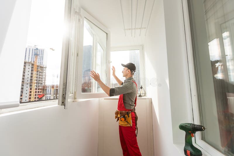 The Worker Installing and Checking Window in the House Stock Photo ...