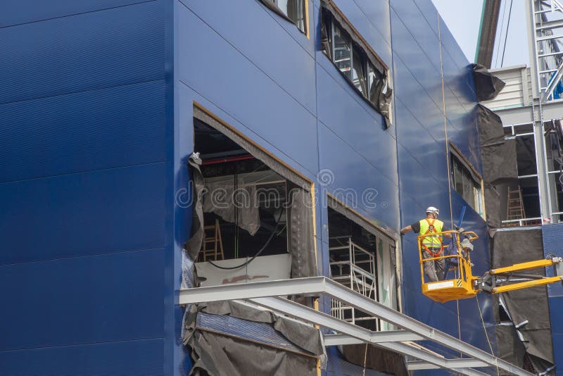 Worker Installing Insulating Panels in a Building Under Construction ...