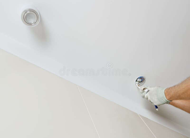 A Worker is Installing an LED Spotlight on the Ceiling Stock Image ...