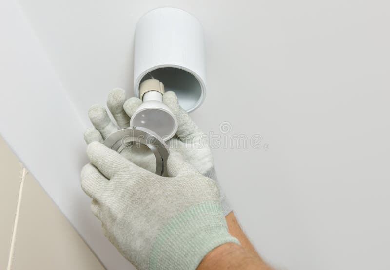 A Worker is Installing an LED Spotlight on the Ceiling Stock Photo ...