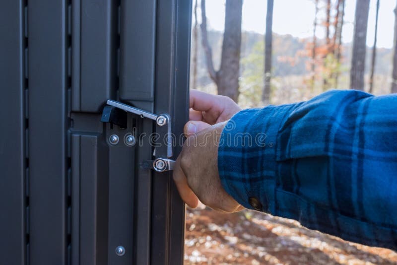 Worker Installing a Metal Gate at Shed in Backyard Stock Photo - Image ...