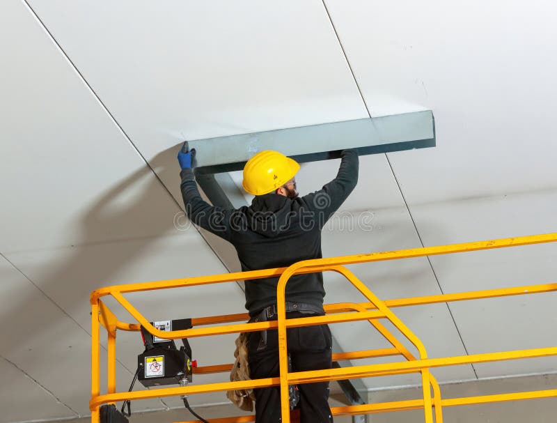 Worker Installing Metal Profile for Large Plasterboard Ceiling Stock ...