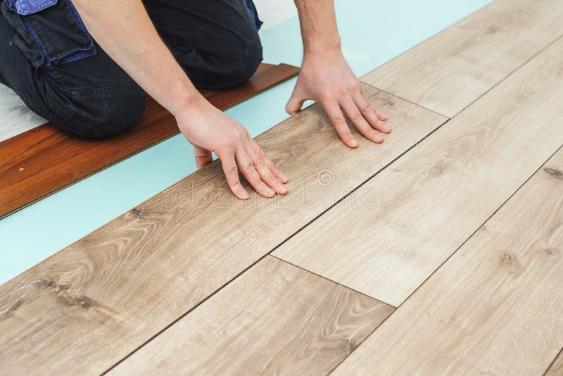Worker Installing New Laminated Wooden Floor. Easy and Quick ...