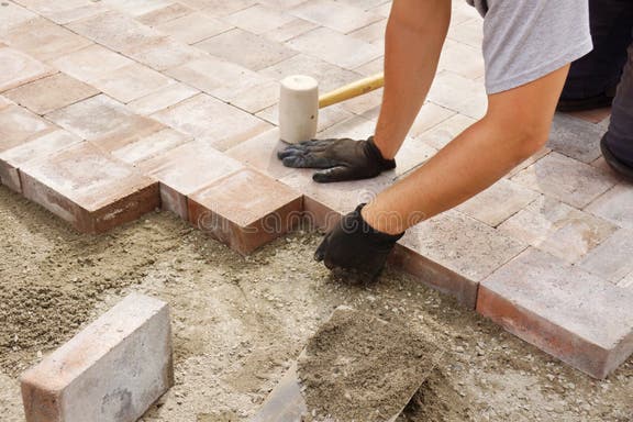 Worker installing paver stock photo. Image of paving - 36220526