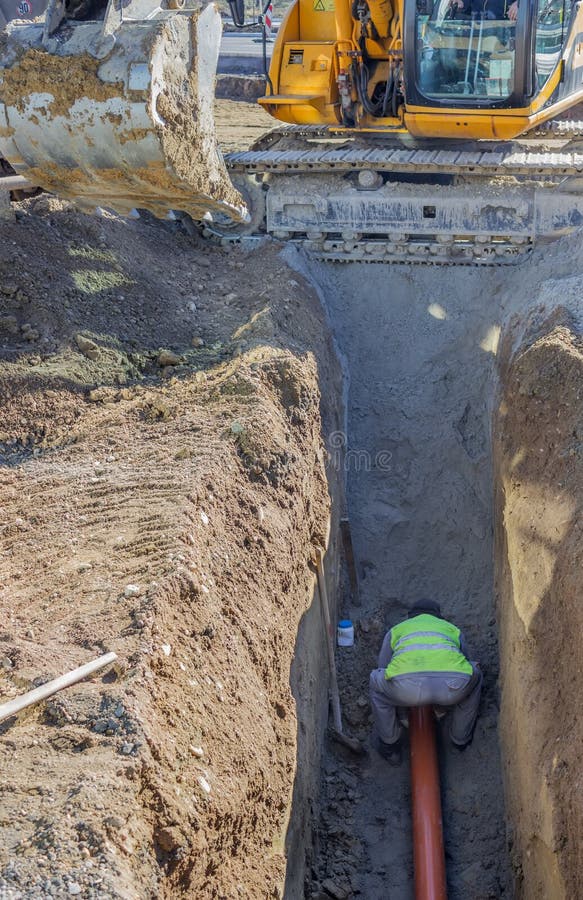 Worker Installing Sewer Pipe in Trench 2 Stock Image - Image of cross ...