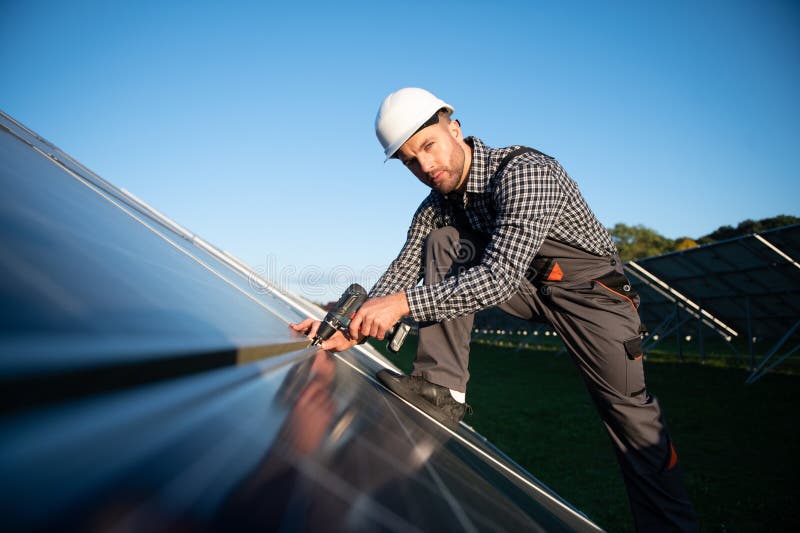 Worker Installing Solar Panel on Metal Beams at Sunny Daytime ...