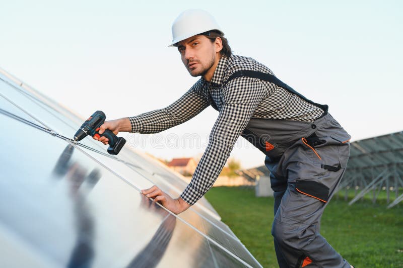 Worker Installing Solar Panel on Metal Beams at Sunny Daytime ...