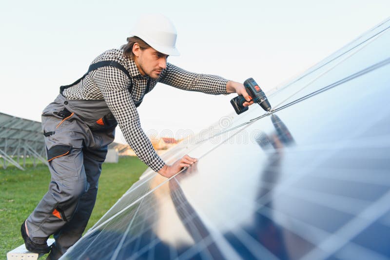 Worker Installing Solar Panel on Metal Beams at Sunny Daytime ...