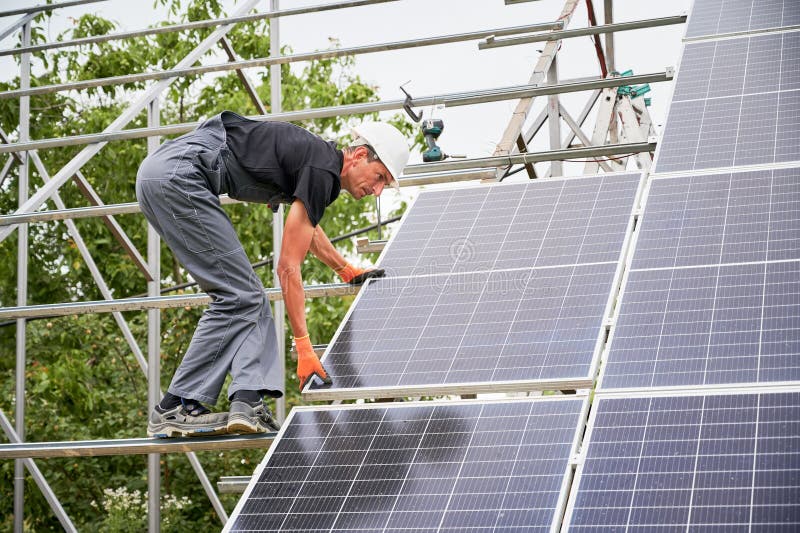 Worker Installing Solar Panels on Metal Beams Stock Photo - Image of ...