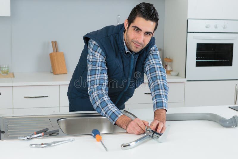 Worker installing tap stock photo. Image of plumber - 198376482