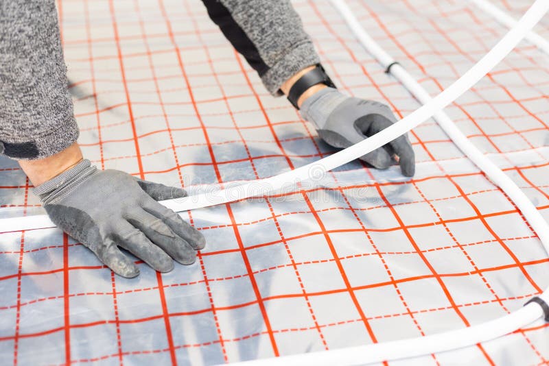 Worker Installing Underfloor Heating System, Water Heating on the New ...